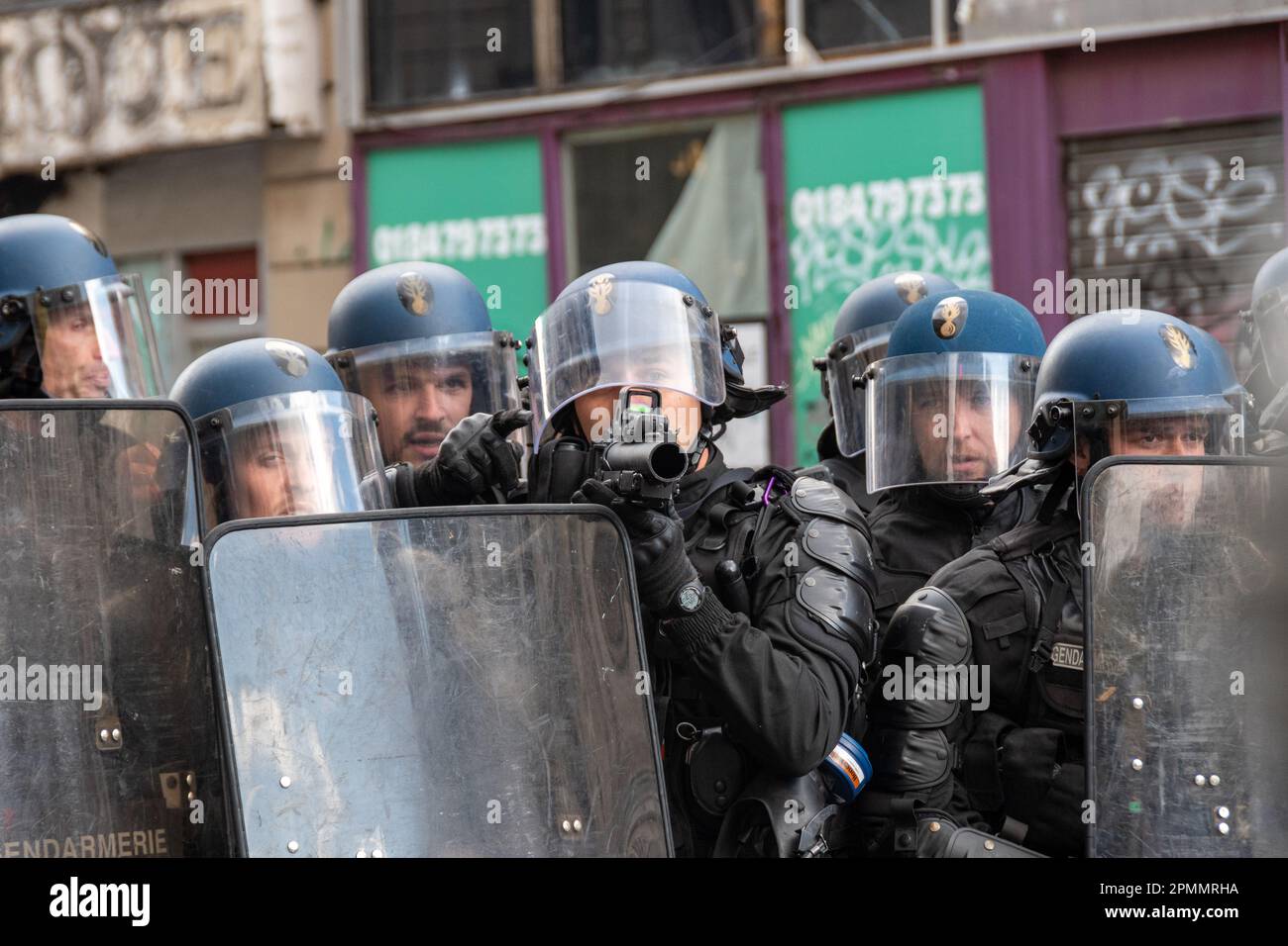 French gendarme aiming with an LBD 40 mm blast ball riot gun, a less ...