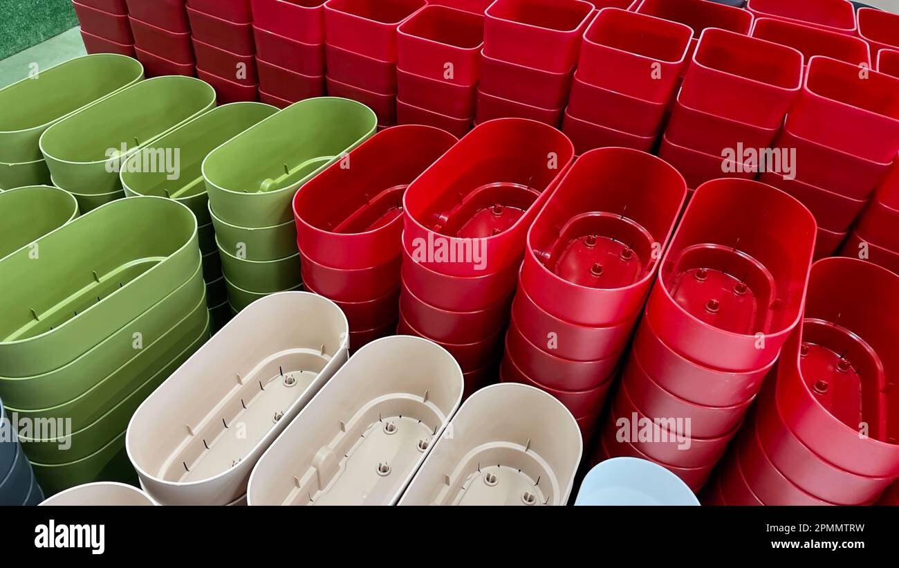 Close-up of empty flower pots in a store or greenhouse. Colorful pots ...