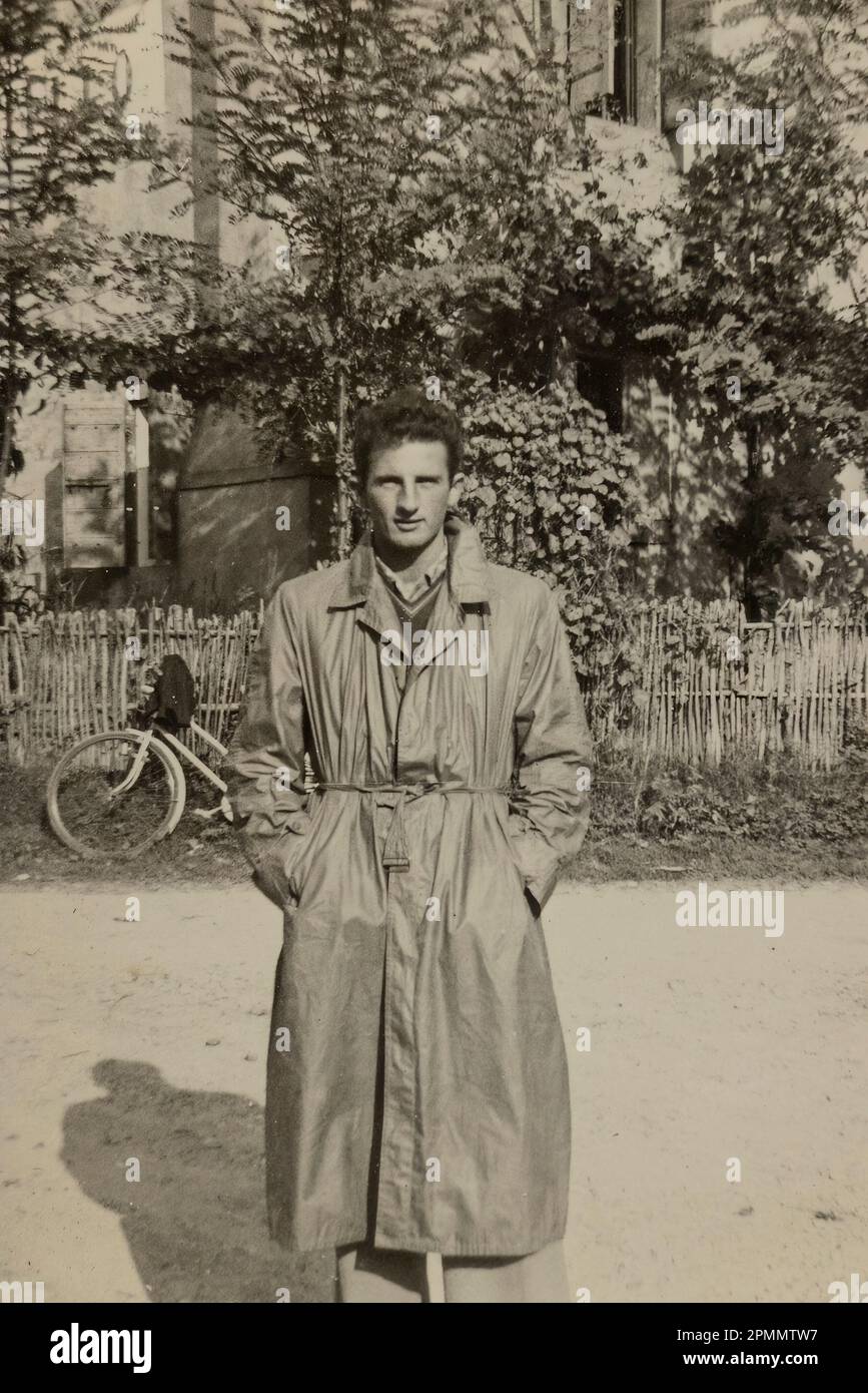 Rome, Italy may 1951: A stylish young man in a long coat and a ...