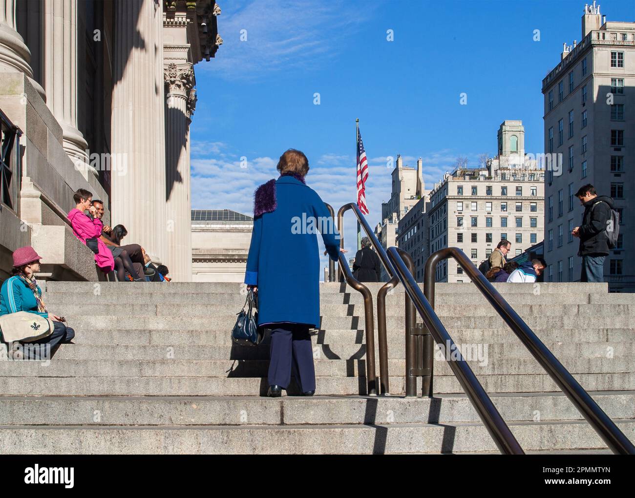 Manhattan, New York, NY, USA; smartly dressed woman climbing steps ...
