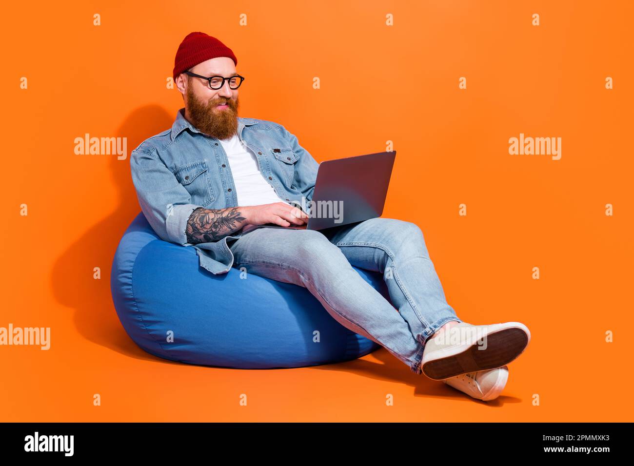 Full body photo of geek nerd guy working on laptop online shopping sit ...