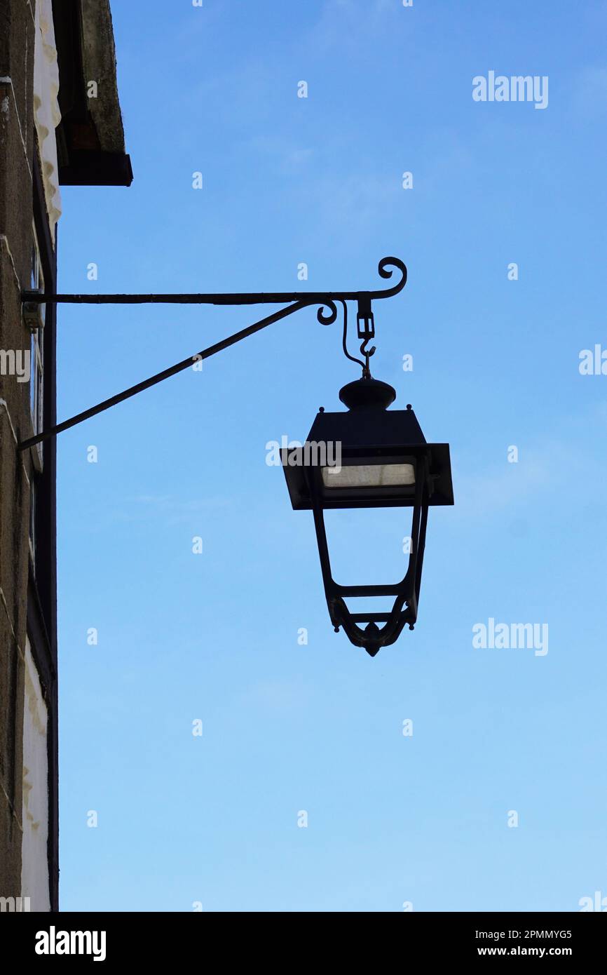 Tradicional street lamp lantern hanging from the wall of a historic ...
