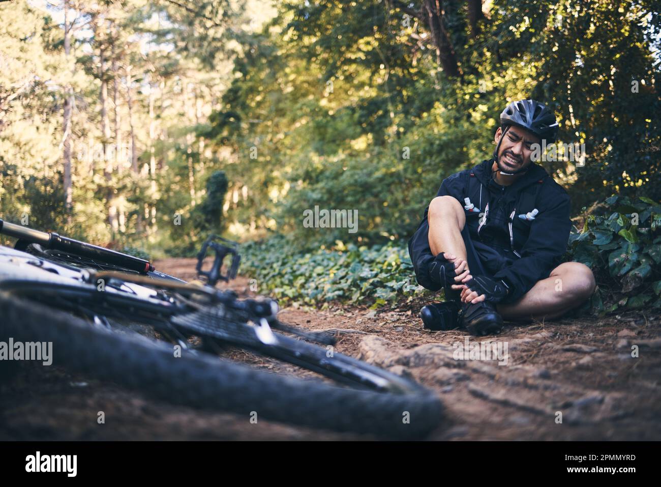 Sports man, injury and bicycle outdoor while cycling on mountain bike ...