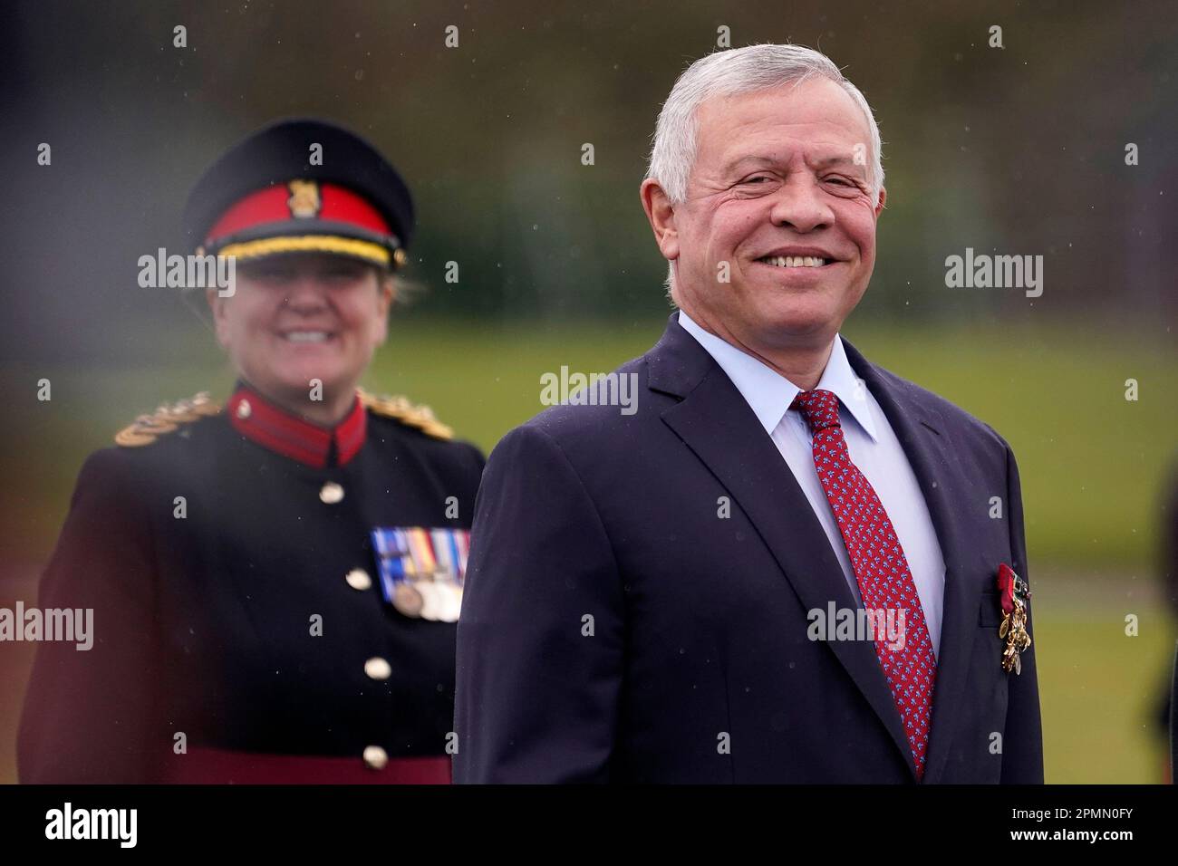 King Abdullah II of Jordan smiles as he waits for Britain's King ...