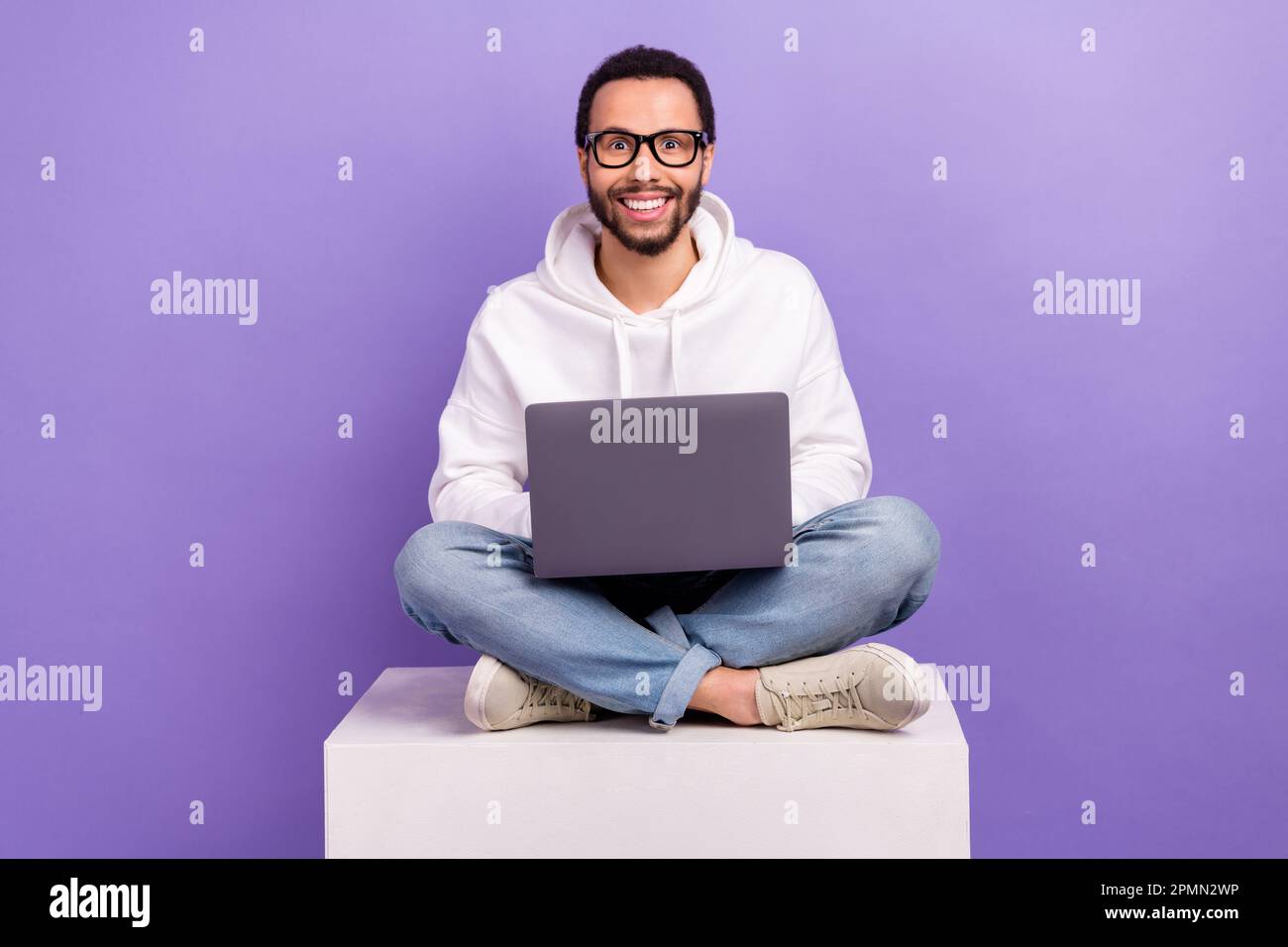 Full body photo of excited surprised man sit box platform using apple ...
