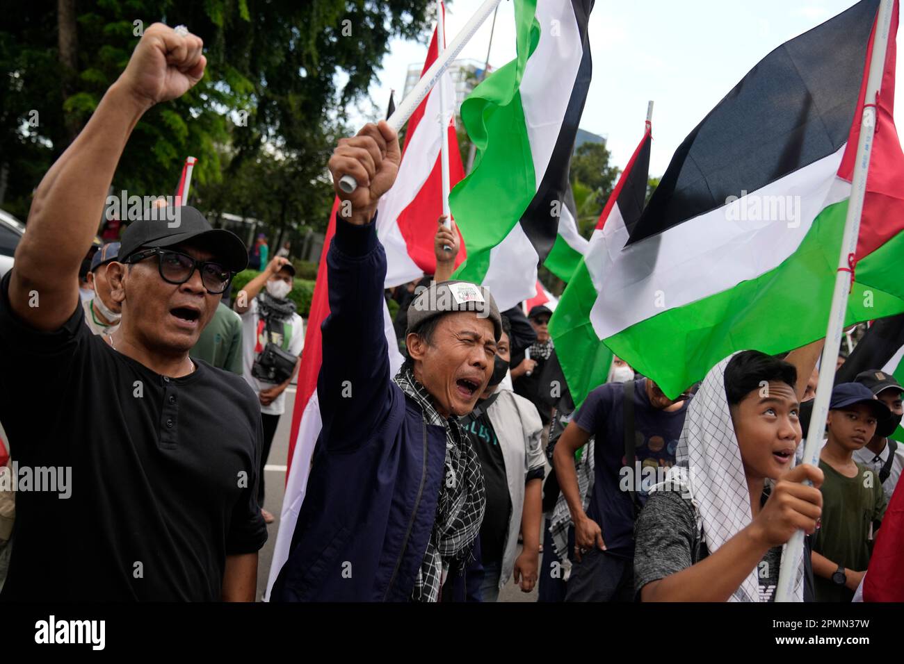 People shout slogans and wave Palestinian flags during a rally marking ...
