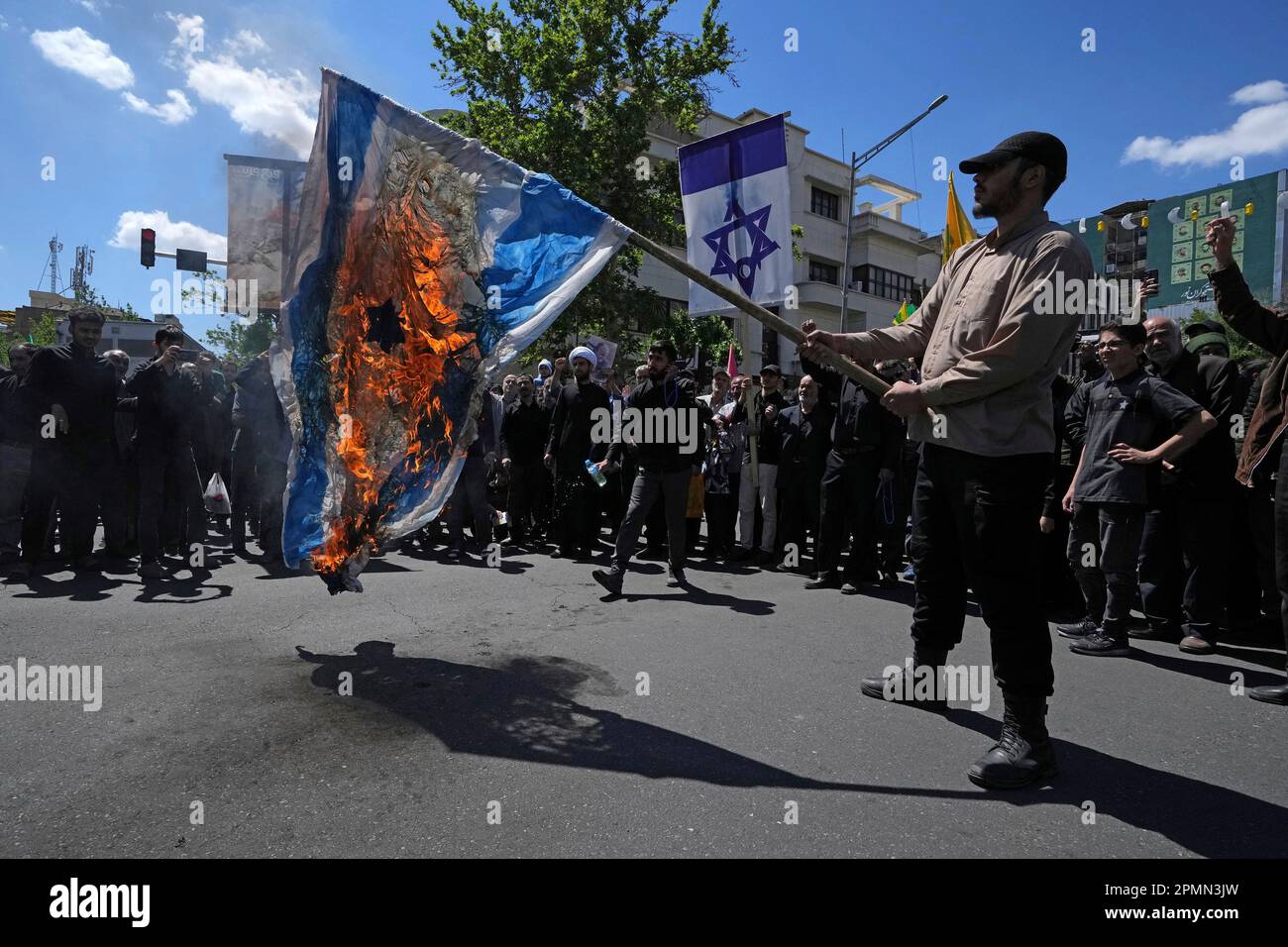 Iranian demonstrators burn a representation of the Israeli flag in ...