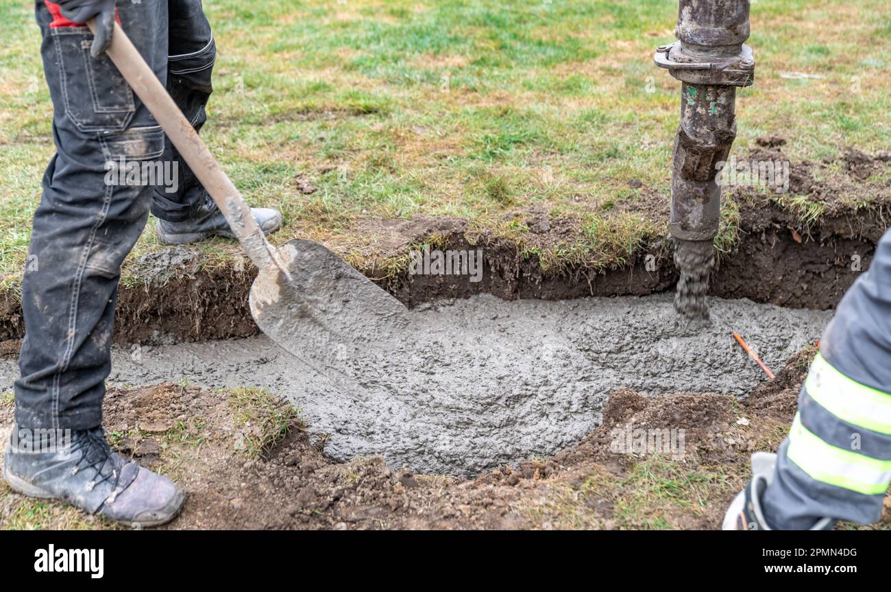 concreting from the pipe of the cement mixing car Stock Photo - Alamy