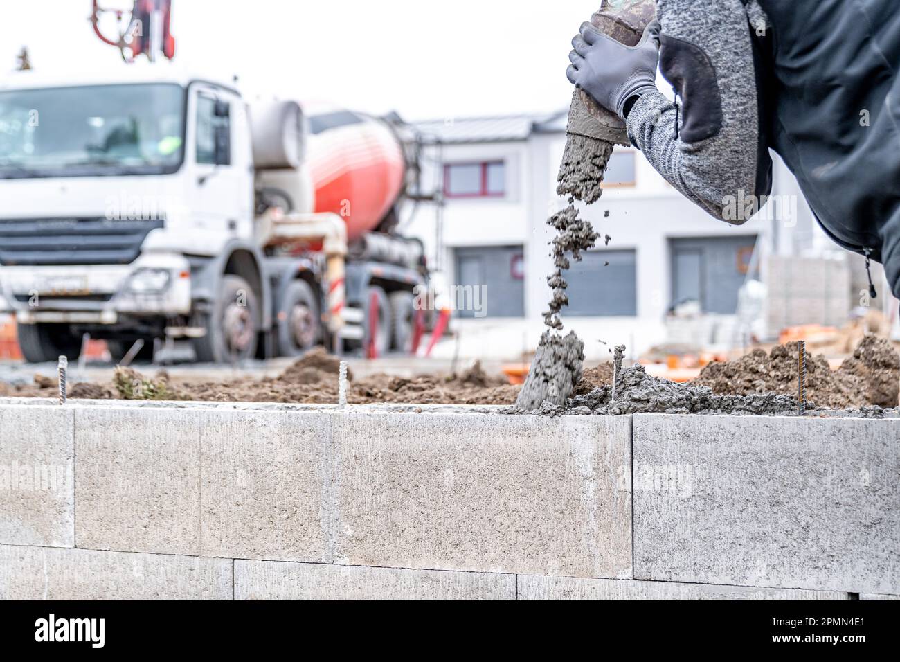concreting from the pipe of the cement mixing car Stock Photo - Alamy