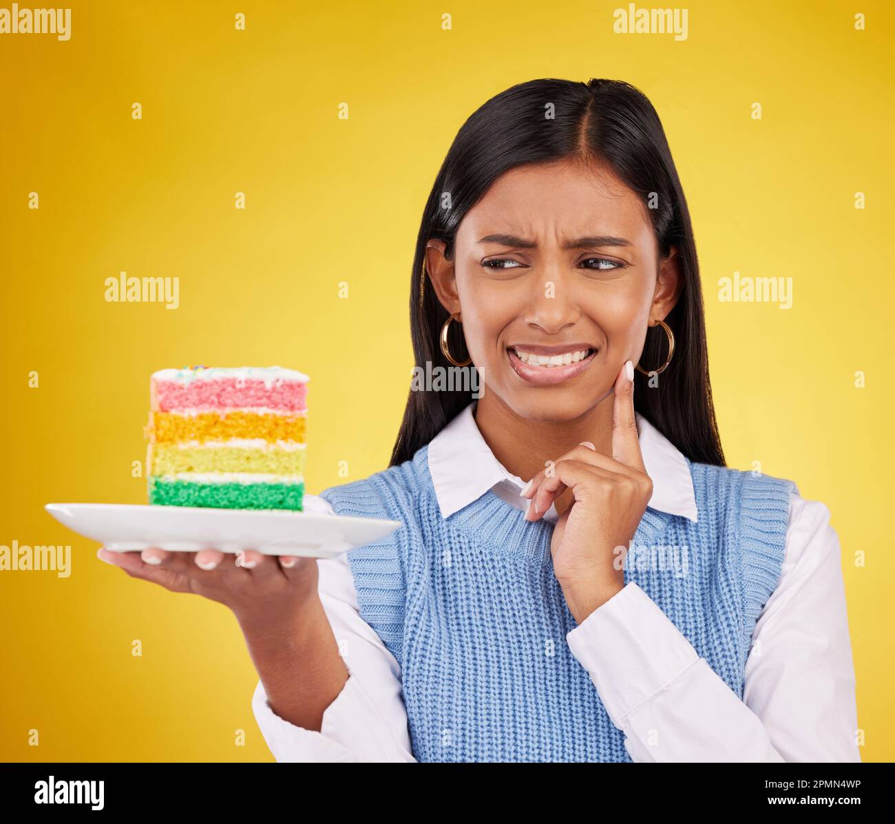 Upset woman, rainbow cake and studio while thinking of birthday ...