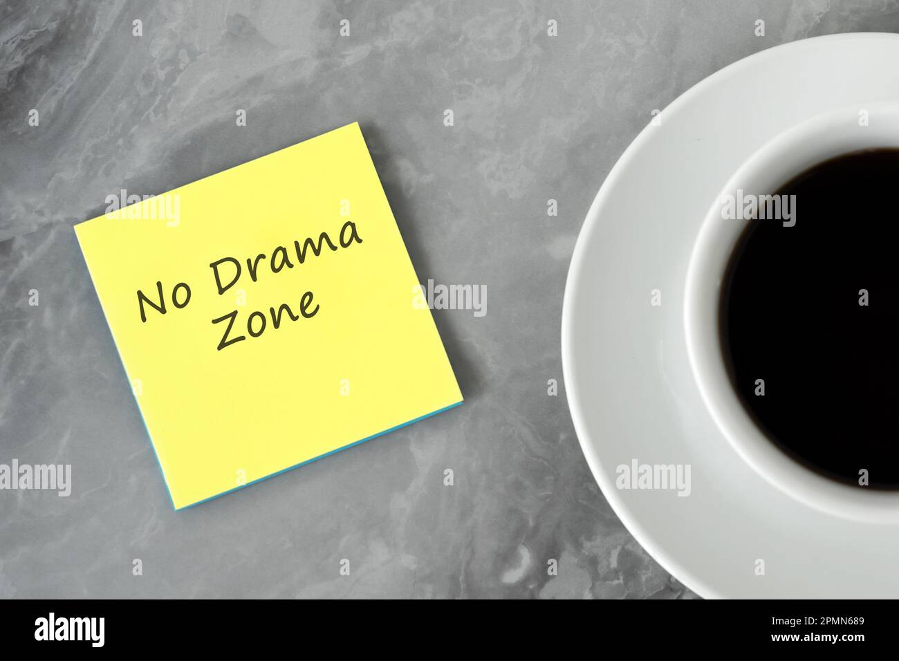 Cup of coffee with adhesive note with text no drama zone Stock Photo ...