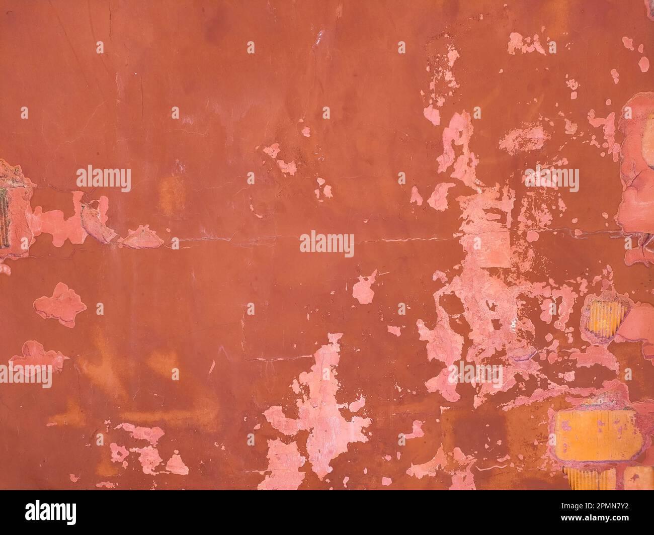 detail of the texture of a brick wall with weathered red paint ...