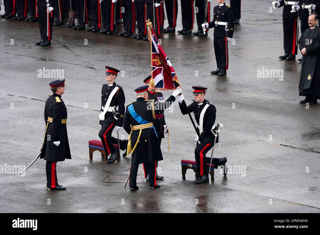 King Charles III touches the new colours during the 200th Sovereign's ...