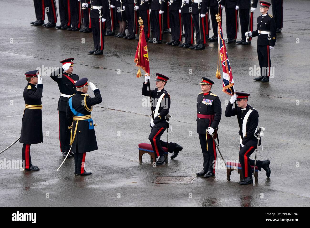 King Charles III salutes the new colours during the 200th Sovereign's ...
