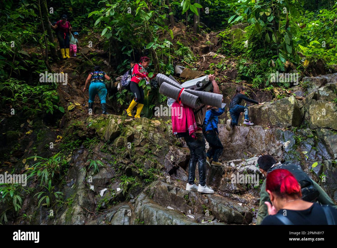 Migrants from Ecuador climb up a rocky trail in the wild and dangerous ...