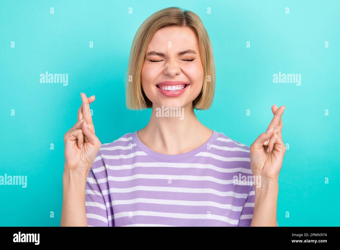 Portrait of young pleading blonde hair crossed her fingers wear striped ...