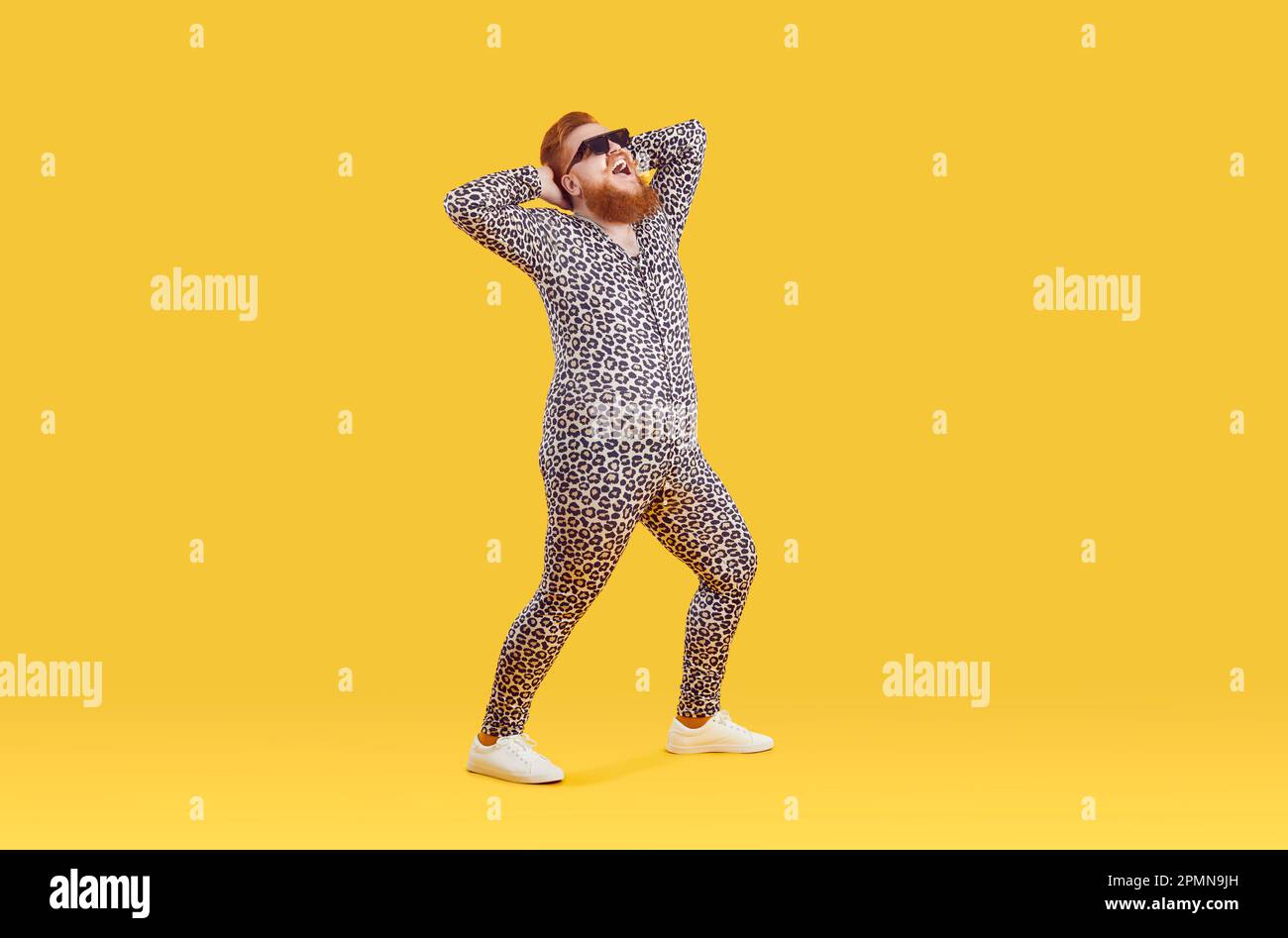 Funny happy plus size man wearing crazy leopard pajamas having fun in ...