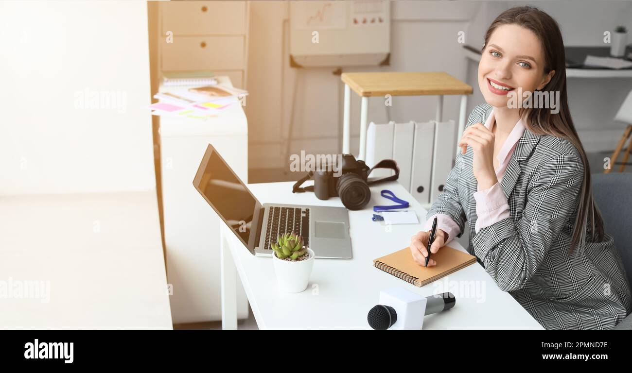 Female journalist working in office Stock Photo - Alamy