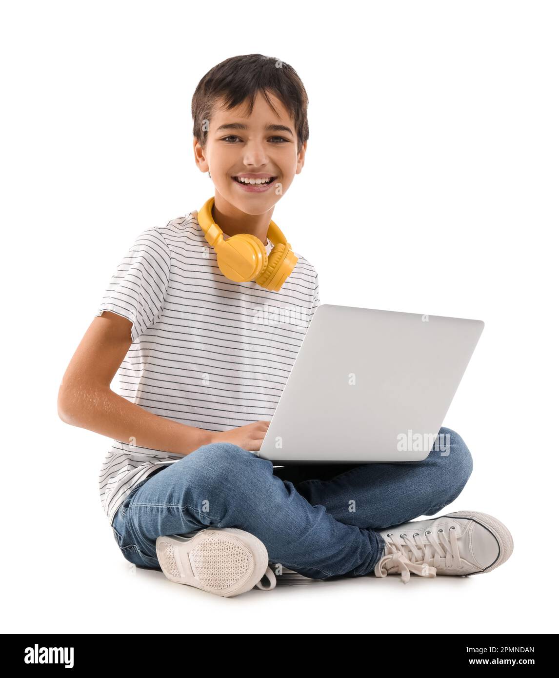 Boy using computer with headphones Cut Out Stock Images & Pictures - Alamy