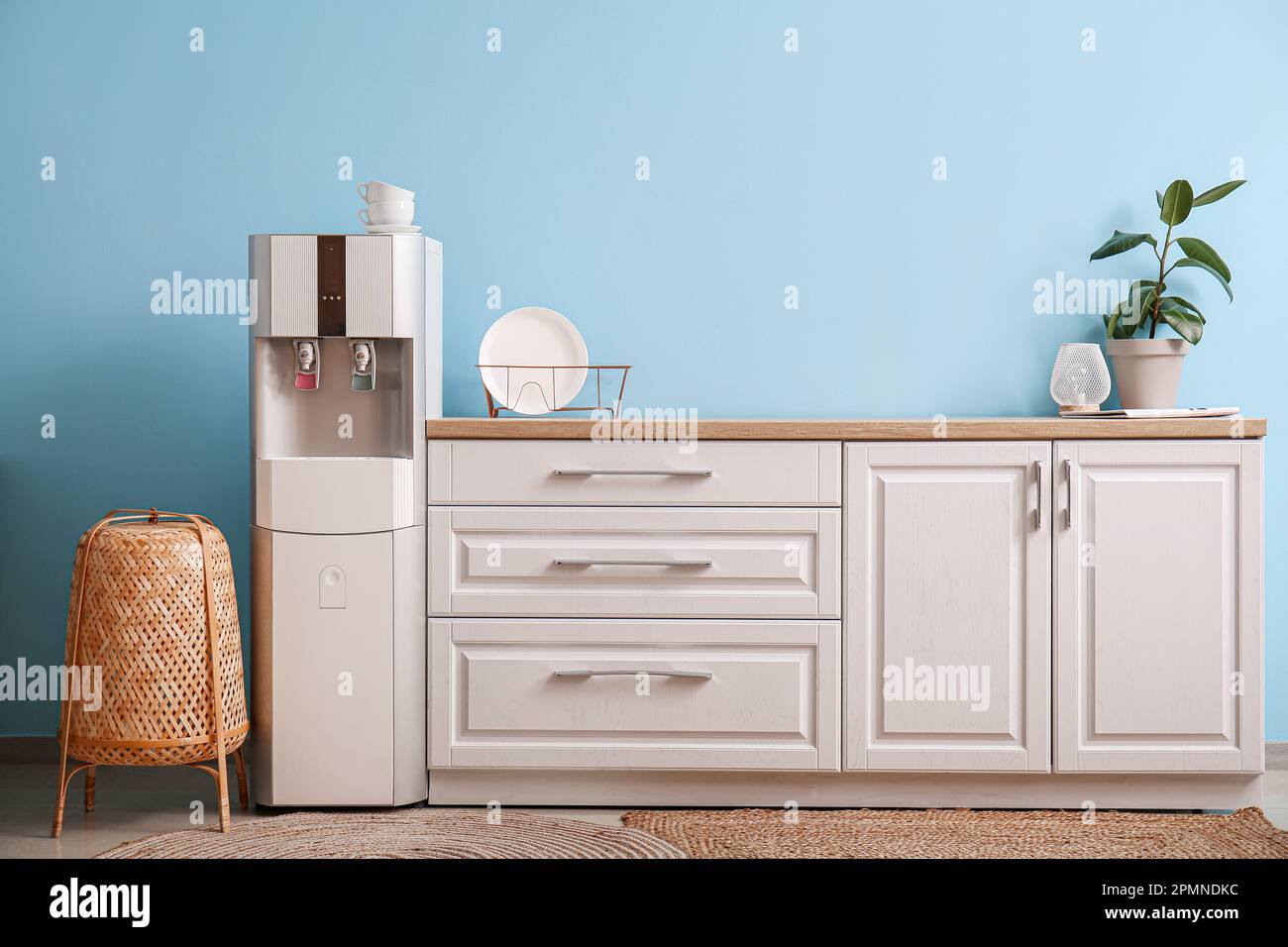 Interior of kitchen with modern water cooler near blue wall Stock Photo ...