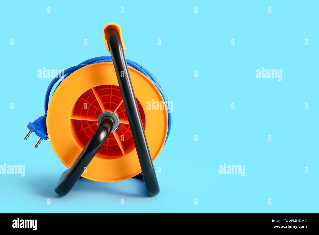 Extension electric cable reel on color background Stock Photo - Alamy