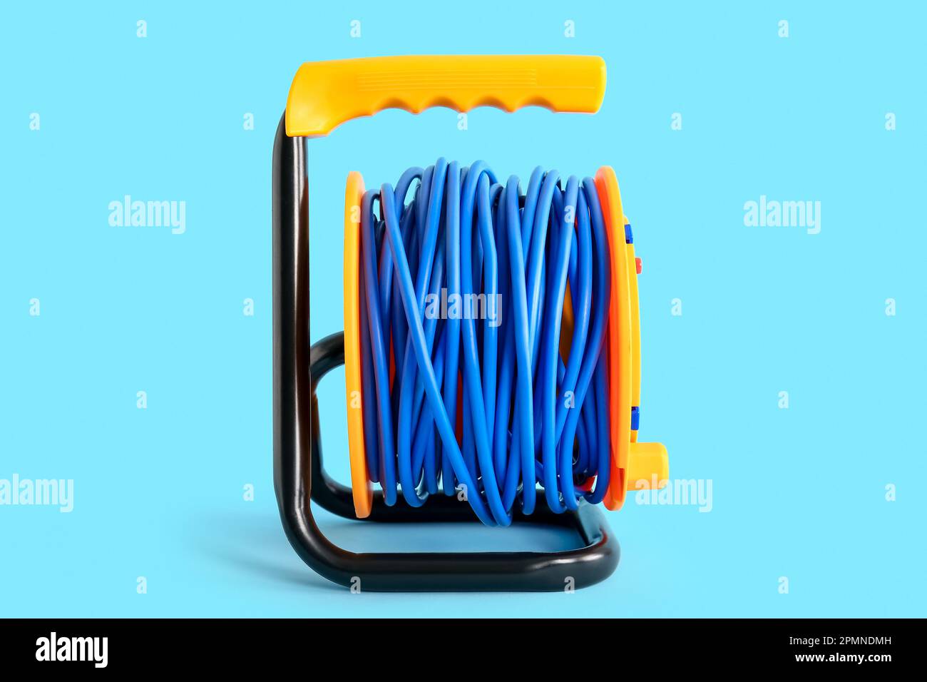 Extension electric cable reel on color background Stock Photo - Alamy