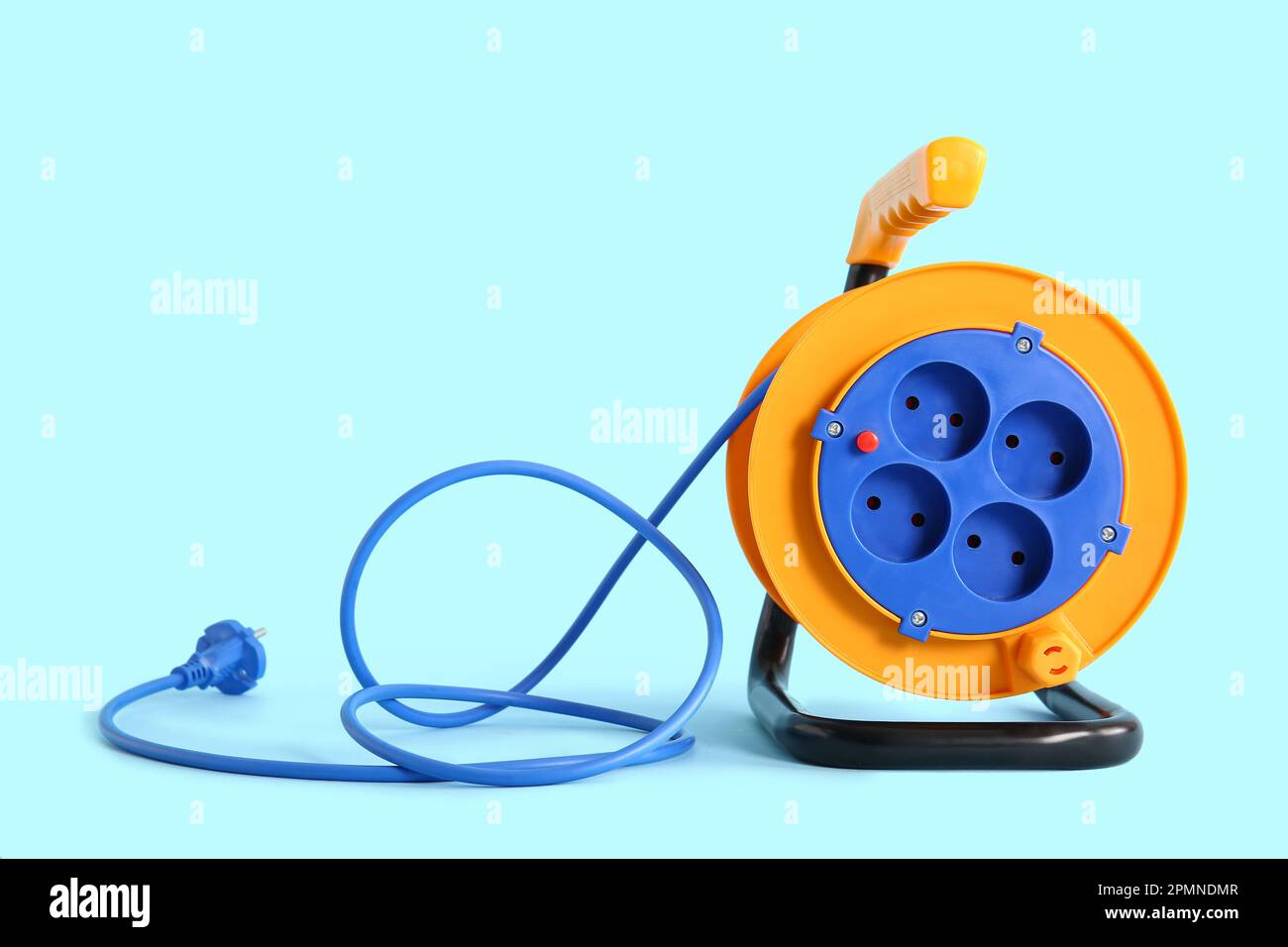 Extension electric cable reel on color background Stock Photo - Alamy