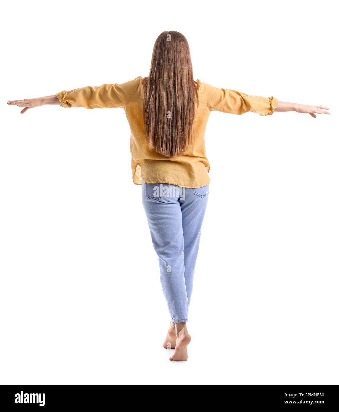Young woman balancing on white background, back view Stock Photo - Alamy