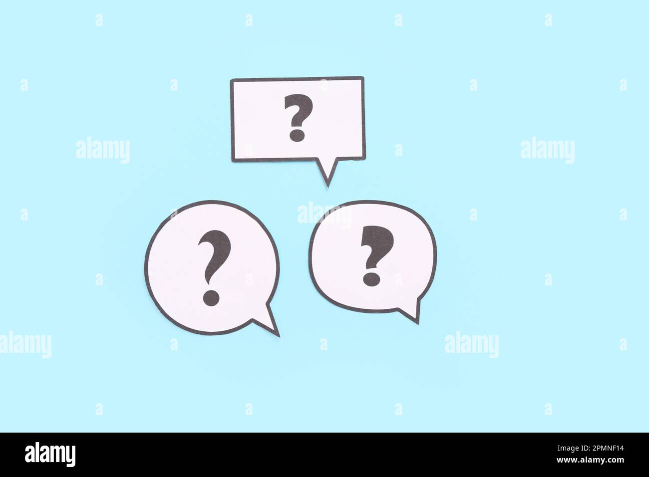 Speech bubbles with question marks on blue background Stock Photo - Alamy