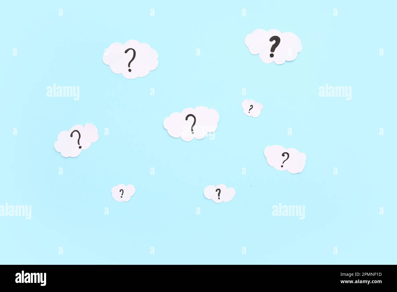 Paper clouds with question marks on blue background Stock Photo - Alamy
