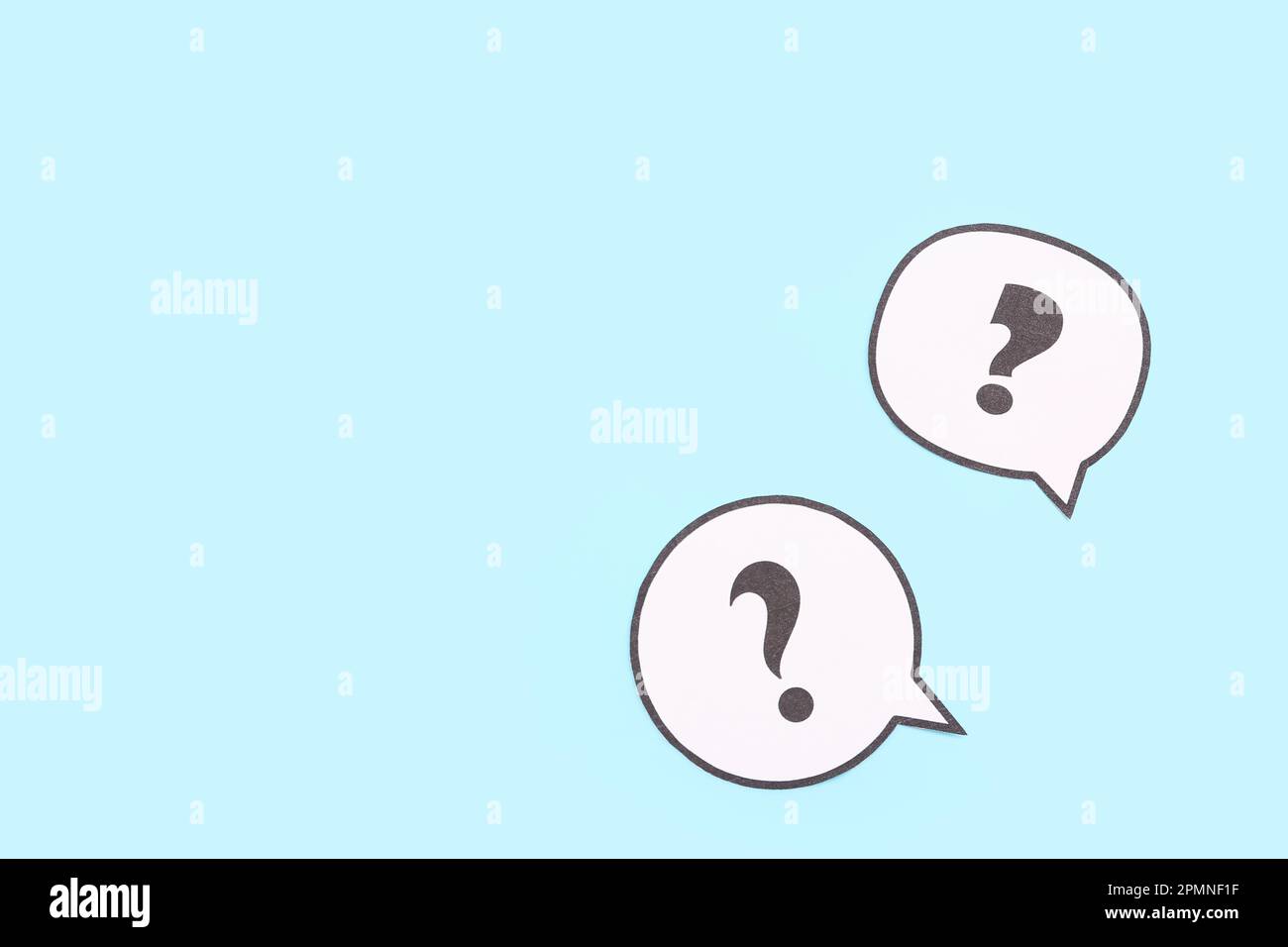 Speech bubbles with question marks on blue background Stock Photo - Alamy