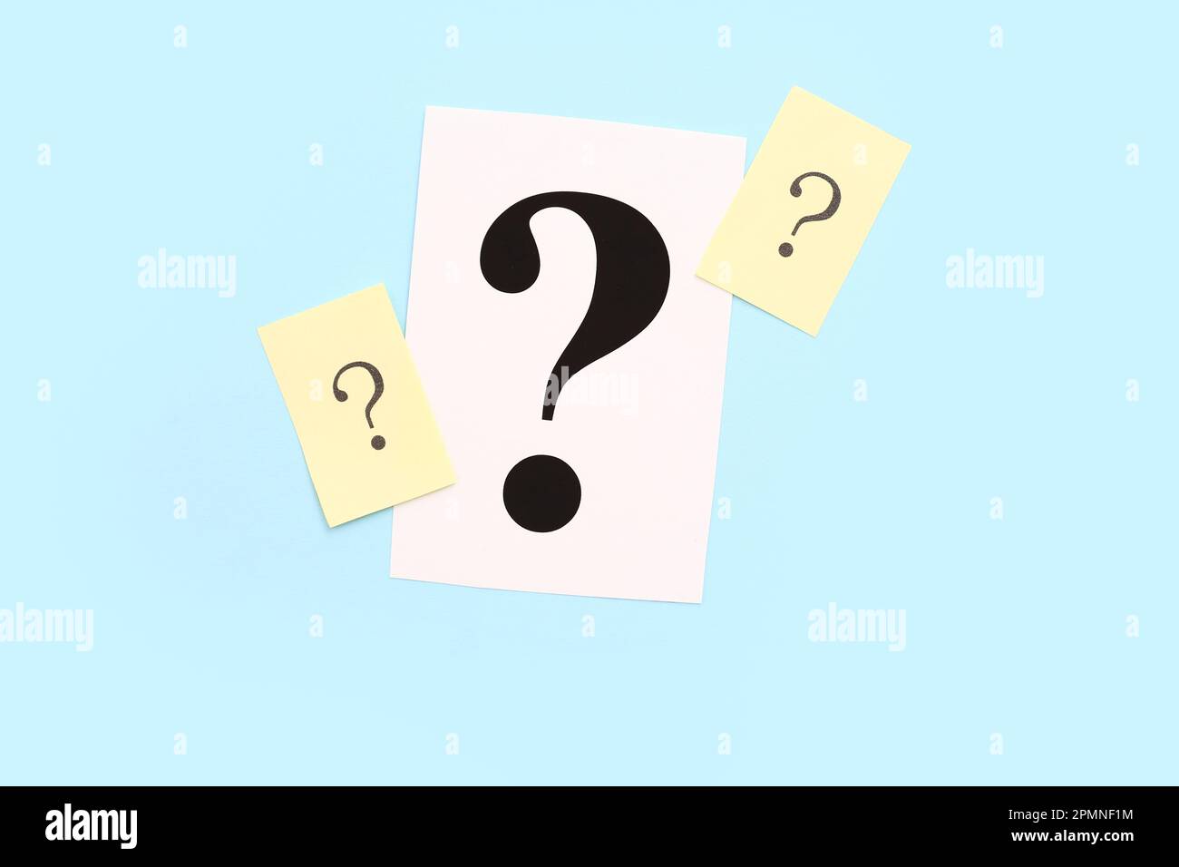 Papers with question marks on blue background Stock Photo - Alamy