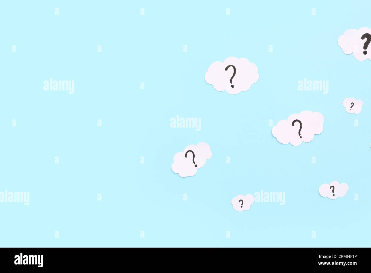 Paper clouds with question marks on blue background Stock Photo - Alamy
