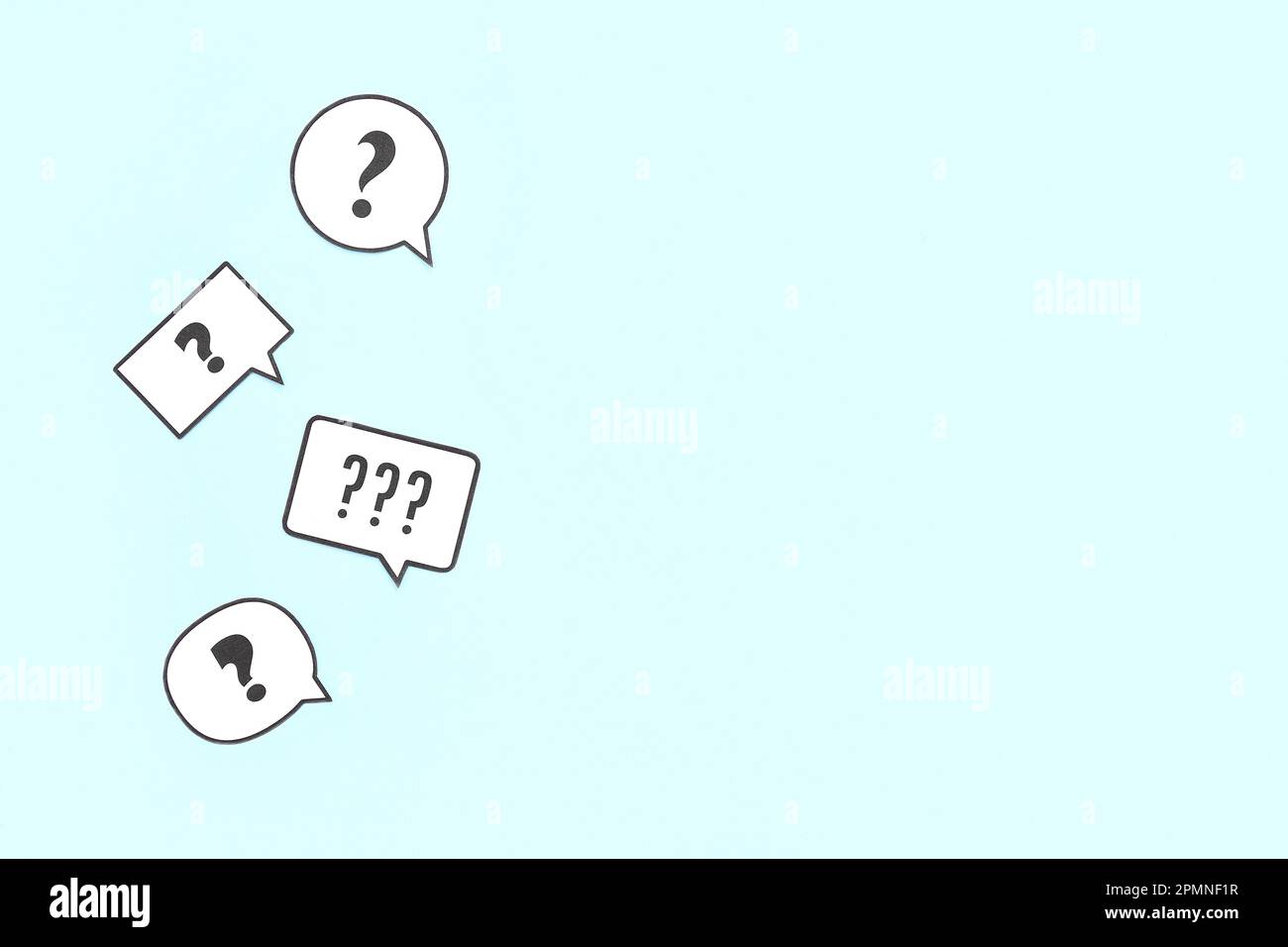 Speech bubbles with question marks on blue background Stock Photo - Alamy