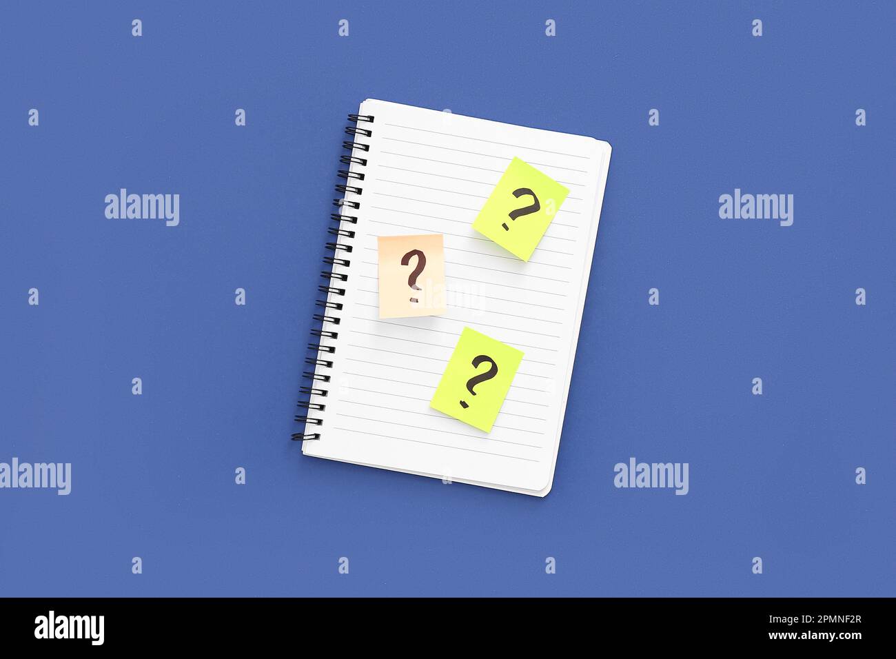 Sticky notes with question marks and notebook on blue background Stock ...