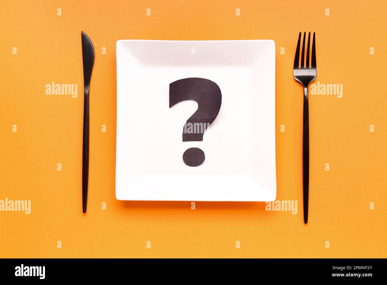 Plate with question mark and cutlery on orange background Stock Photo ...