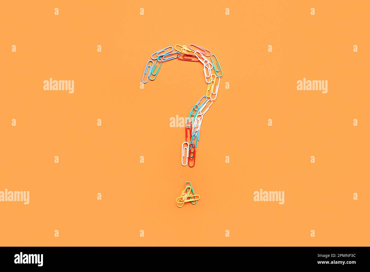 Question mark made of paper clips on orange background Stock Photo - Alamy