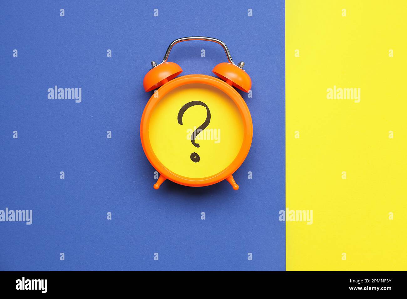 Alarm clock with question mark on color background Stock Photo - Alamy