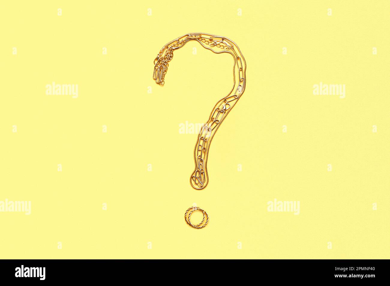 Question mark made of jewelry on yellow background Stock Photo - Alamy