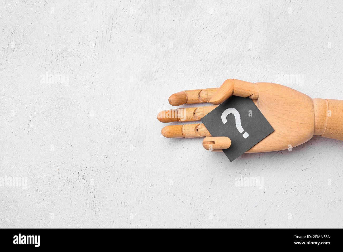 Wooden hand with paper question mark on white background Stock Photo ...