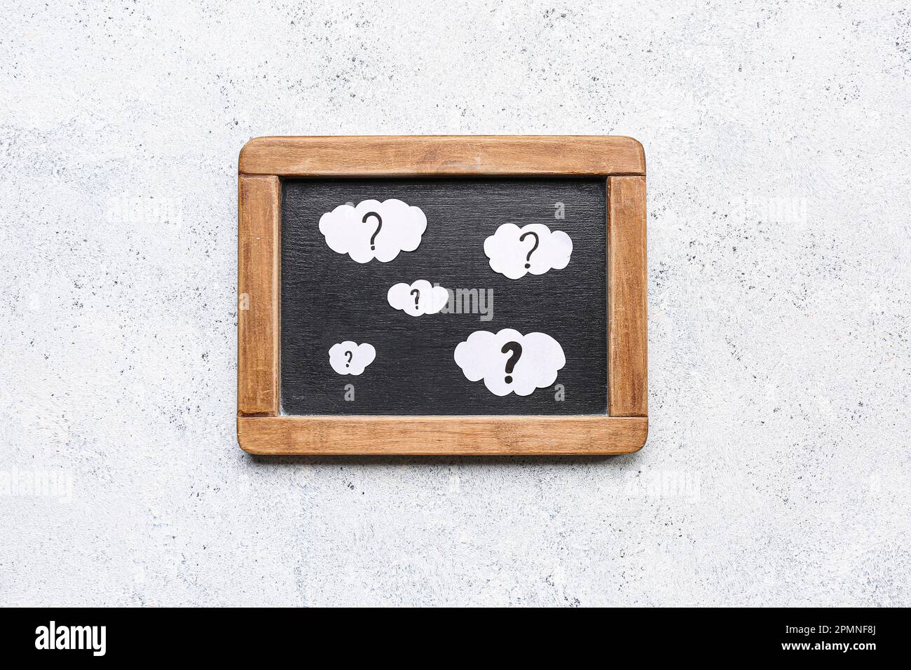 Chalkboard with clouds and question marks on white background Stock ...