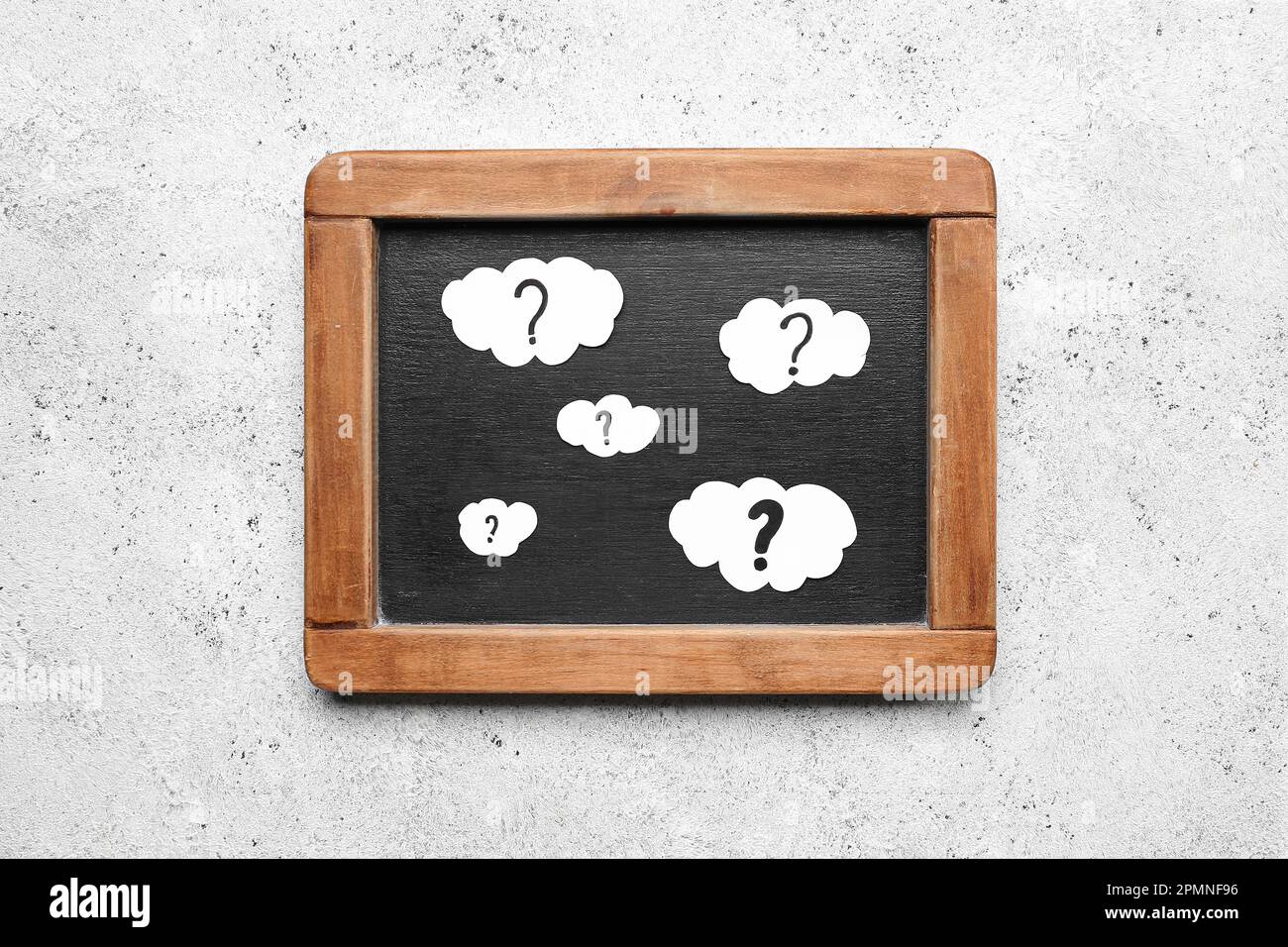 Chalkboard with clouds and question marks on white background Stock ...