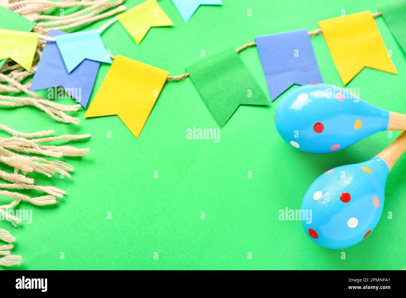 Frame made of Mexican maracas, flags and serape on green background ...