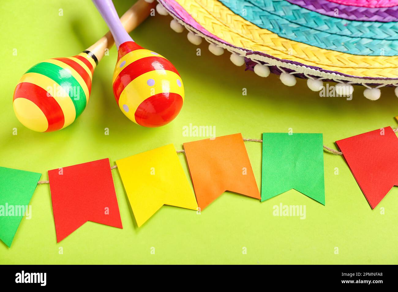 Mexican maracas with sombrero hat and flags on green background ...