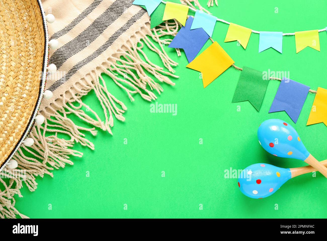 Frame made of Mexican maracas, flags and serape on green background ...