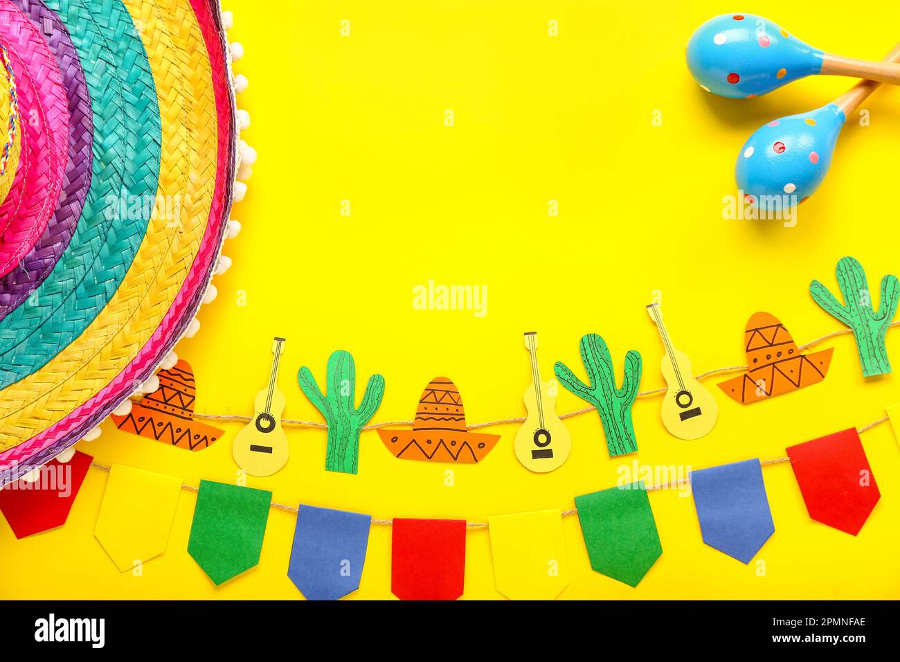 Frame made of Mexican maracas, paper garland, flags and sombrero hat on ...