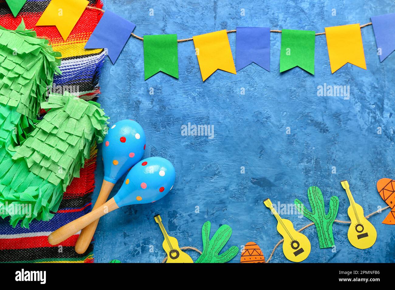 Frame made of Mexican maracas, pinata, garland and flags on grunge ...