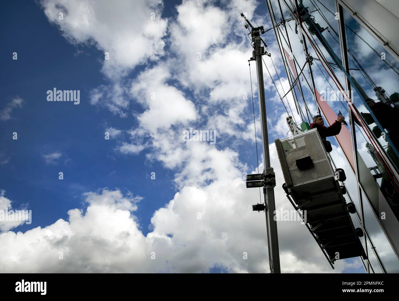 ROTTERDAM - 14/04/2023, Abseilers hang on the 57th floor of the ...