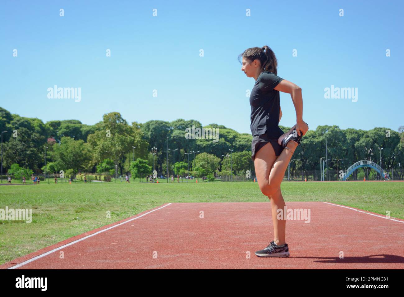 side view of young argentinian latin woman, wearing black clothes ...