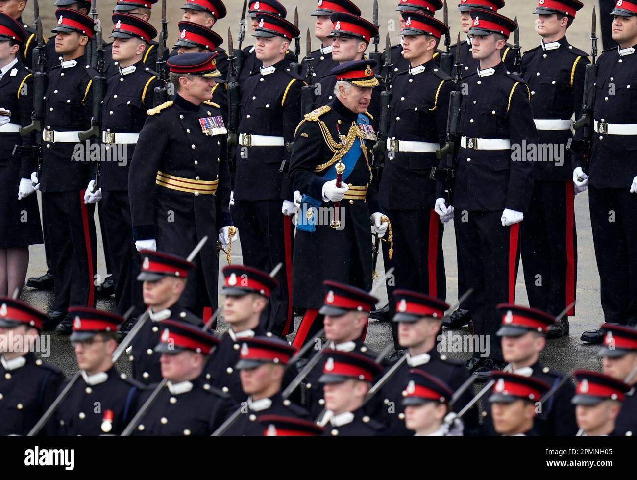 King Charles III (right) inspects Officer Cadets on parade during the ...